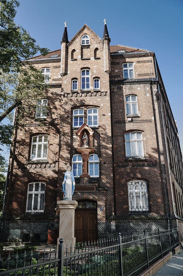 Statue of the Virgin Mary in Front of a Red Brick Tenement Stock Photo ...