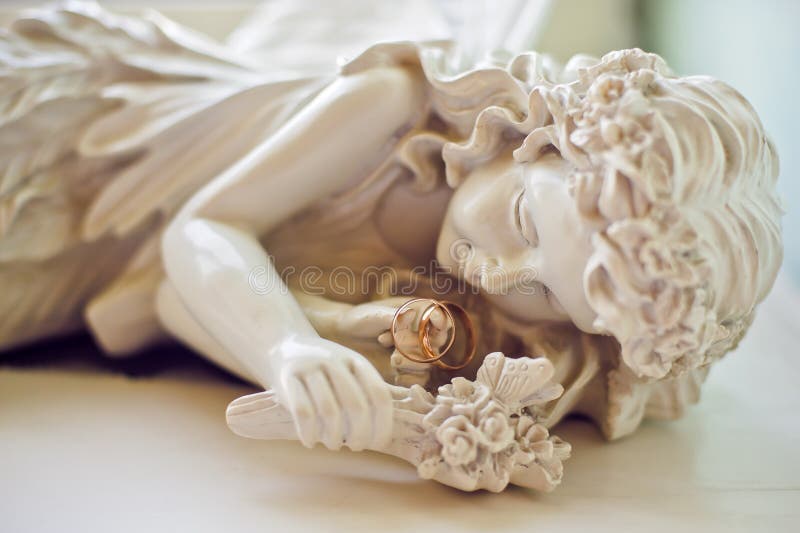 Statue and wedding rings stock image. Image of beauty - 75582877