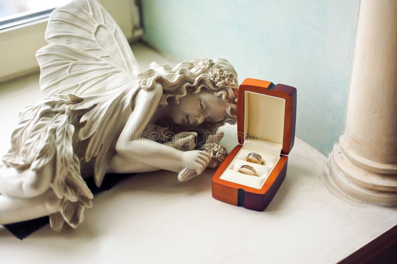 Statue and wedding rings stock image. Image of casual - 75583247