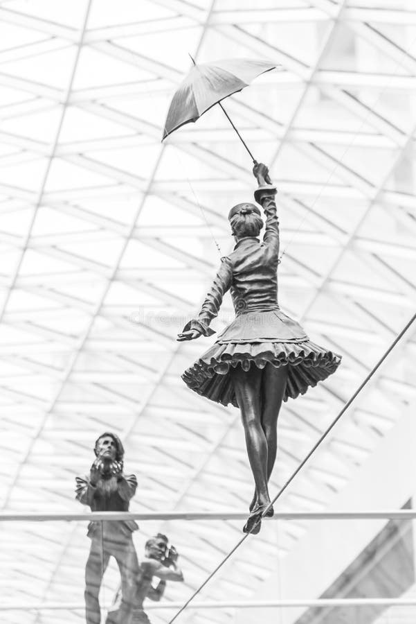 Statue of a Woman Balancing on a Thin Rope Stock Image - Image of ...