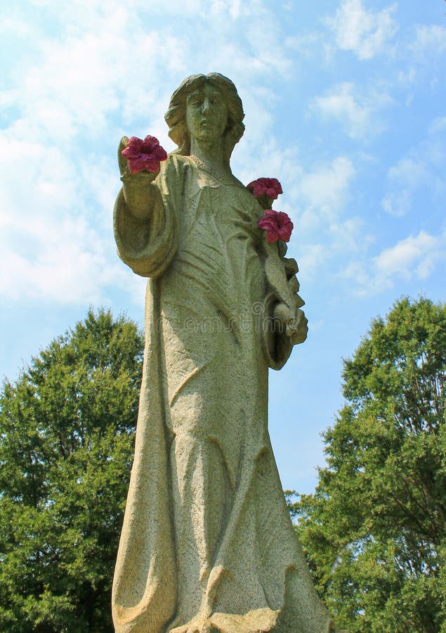Statue of a Woman with Flowers Stock Image - Image of statue, love ...