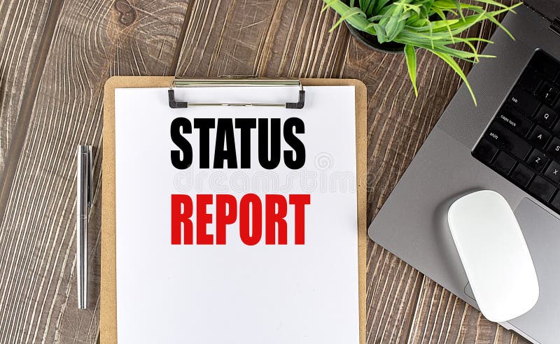 STATUS REPORT Text on Clipboard Paper with Laptop, Mouse and Pen Stock ...