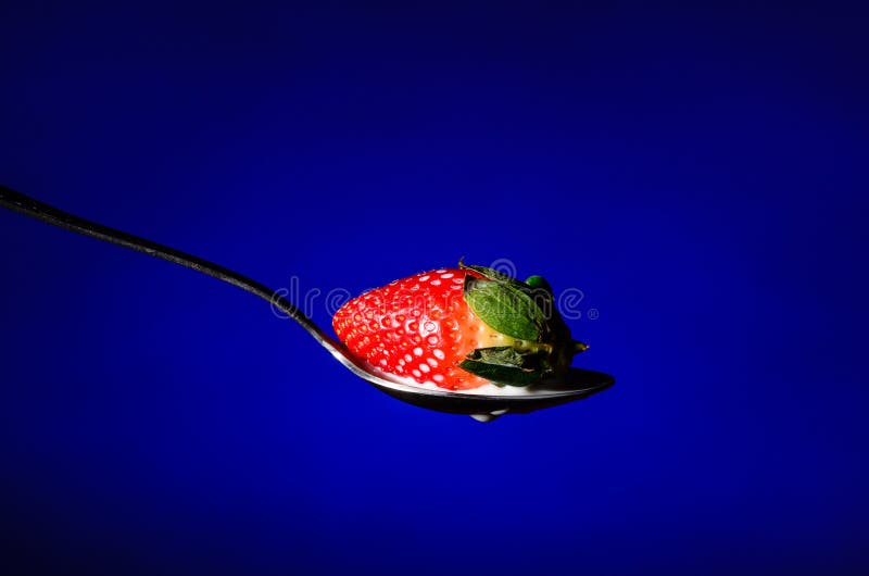 Stawberry Dropping in a Spoon Stock Photo - Image of abstract, color ...