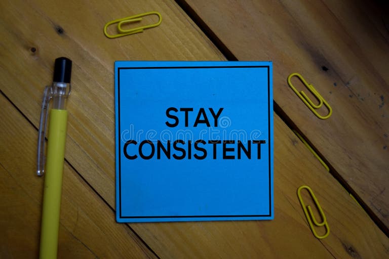 Stay Consistent Write on a Sticky Note Isolated on Wooden Background ...