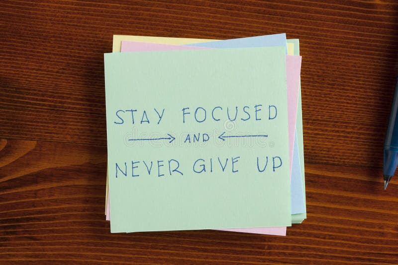Stay Focused and Never Give Up Written on Note Stock Image - Image of ...