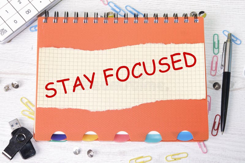 STAY FOCUSED a Phrase on a Piece of Paper Next To Stationery Stock ...