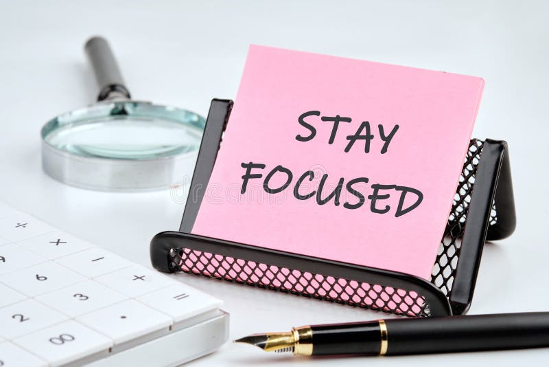 STAY FOCUSED on a Pink Sticker in a Composition with Business ...