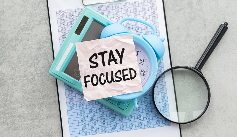 Stay Focused Text Concept Write on Paper on Calculator and Office Clock ...