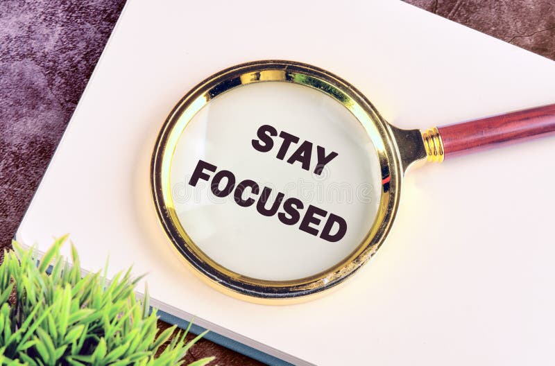 STAY FOCUSED Write in a Notebook through a Magnifying Glass, Top View ...