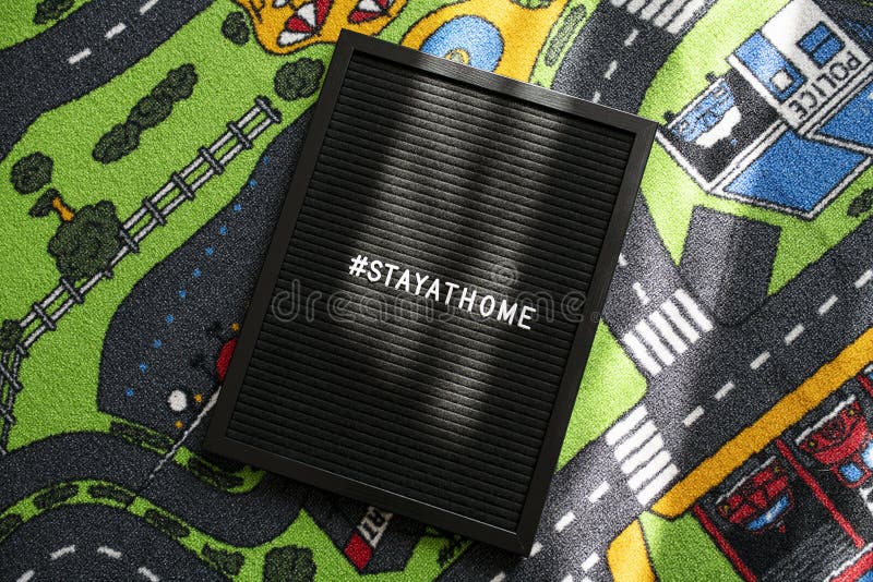 Stay at Home Message Written on Letter Board, on Kids Carpet Stock ...
