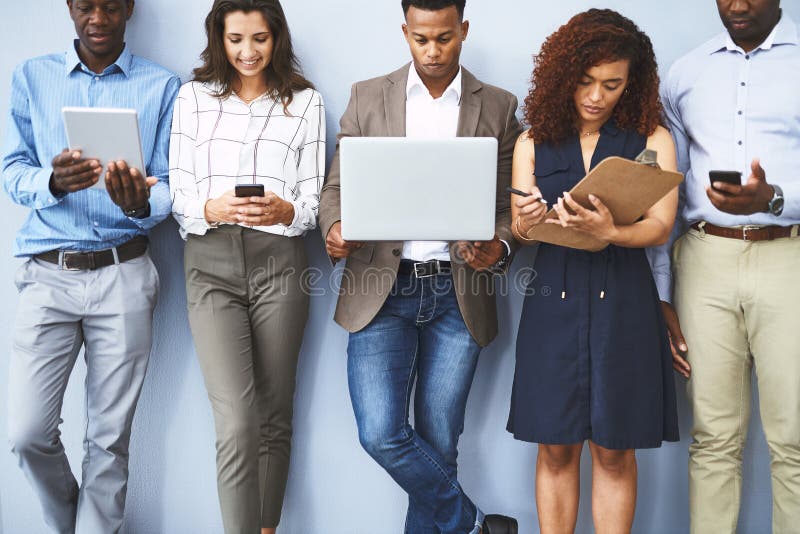 Stay Informed, Stay Ready. Studio Shot of a Group of Businesspeople ...