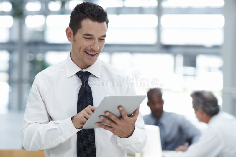 Staying Connected. a Handsome Businessman Looking Down at the Touchpad ...