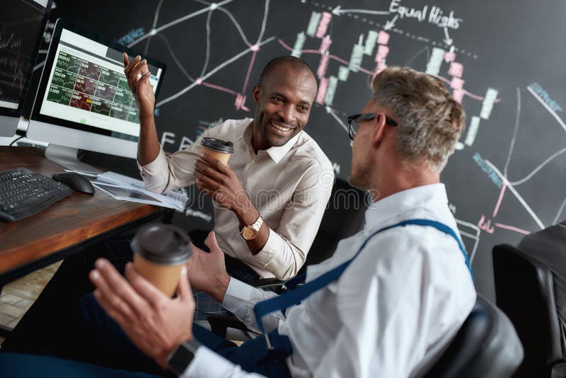 Staying Financially Healthy. Two Diverse Colleagues Traders Discussing ...