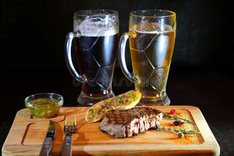 Steak and Beer. Tasty Steak. Dark and Light Beers for Steak. Stock ...