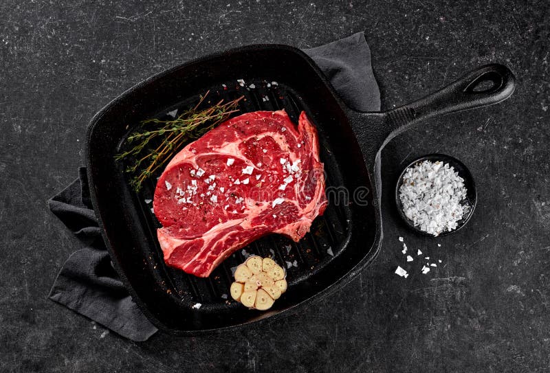 Steak on Cooking Pan with Salt,thyme and Garlic Stock Image - Image of ...