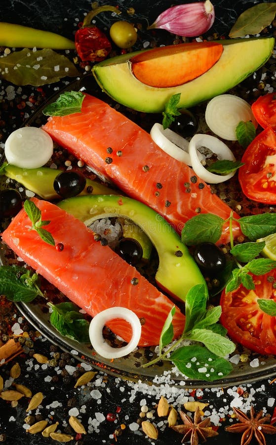 Steak of Red Fish with Spices and Avocado on a Dark Background ...