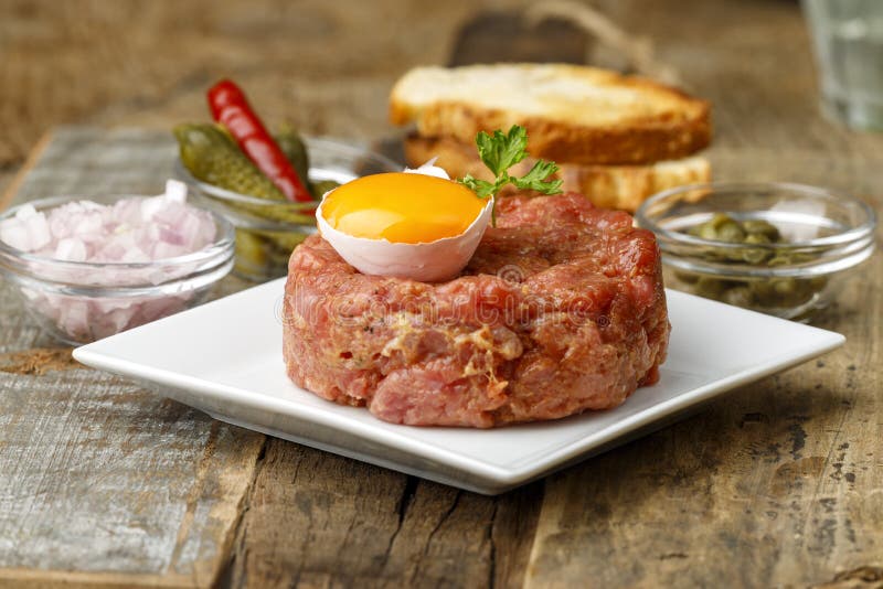 Steak tartare with egg stock photo. Image of dish, baguette - 205295482