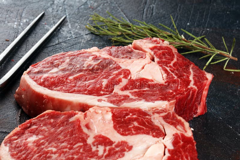 Steak. Two Fresh Raw Rib-eye Steak with Rosmary in a Rustic Style Table ...