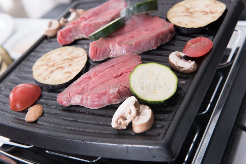 Steaks and Mushrooms on the Raclette Cooking Stock Photo - Image of ...