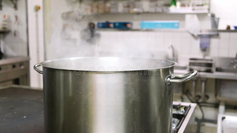 Steam Rising from a Boiling Pot in a Busy Restaurant Kitchen Setting ...