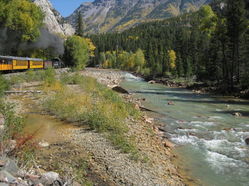 Steam Train Along Mountain Stream Stock Photo - Image of landscape ...