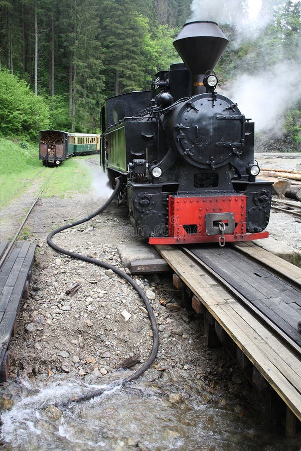 Steam Train Refilling with Water Stock Photo - Image of water, bridge ...