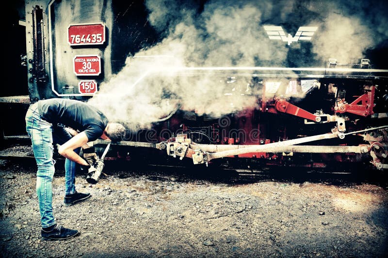 Mechanic on a steam train editorial photography. Image of maramures ...