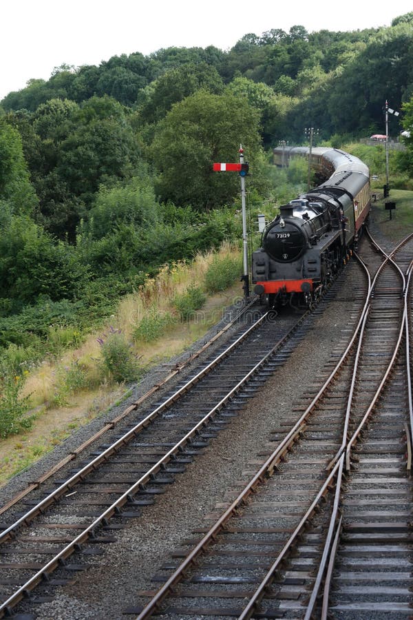 Steam train turning corner editorial photo. Image of tree - 43248631