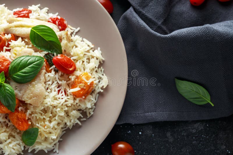 Steamed Cod Fish with Rice and Cherry Mix Tomatoes and Basil Herbs in a ...