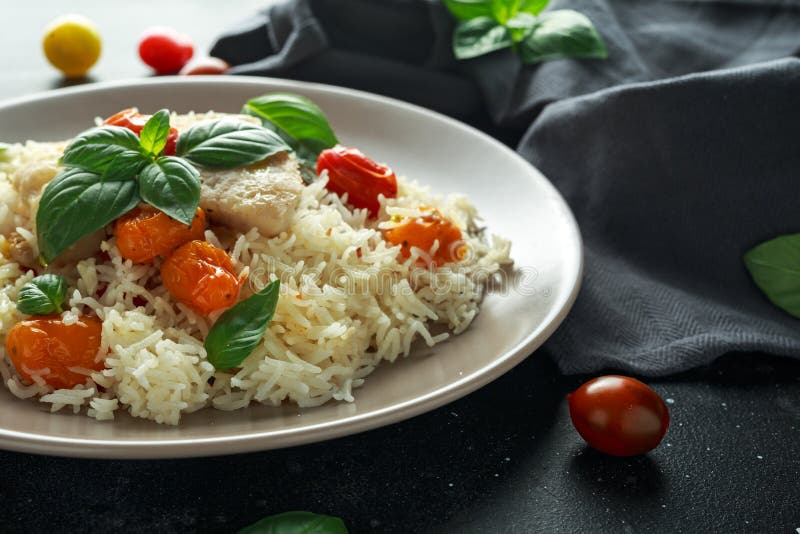 Steamed Cod Fish with Rice and Cherry Mix Tomatoes and Basil Herbs in a ...