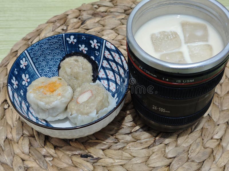Steamed Dimsum and Iced Milk in a Unique Camera Lens Cup Stock Photo ...