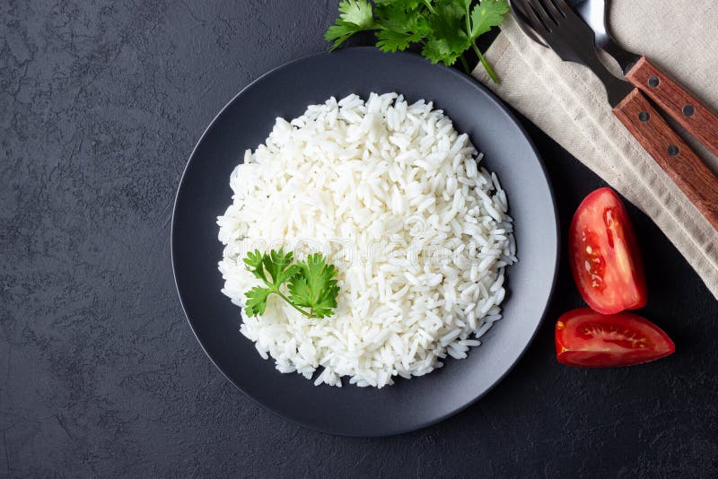 Steamed Rice on Black Plate. Black Stone Background. Stock Photo ...