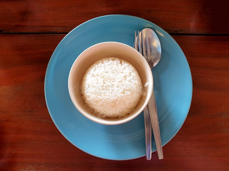 Steamed Rice in a Bowl with a Spoon and Fork Stock Photo - Image of ...