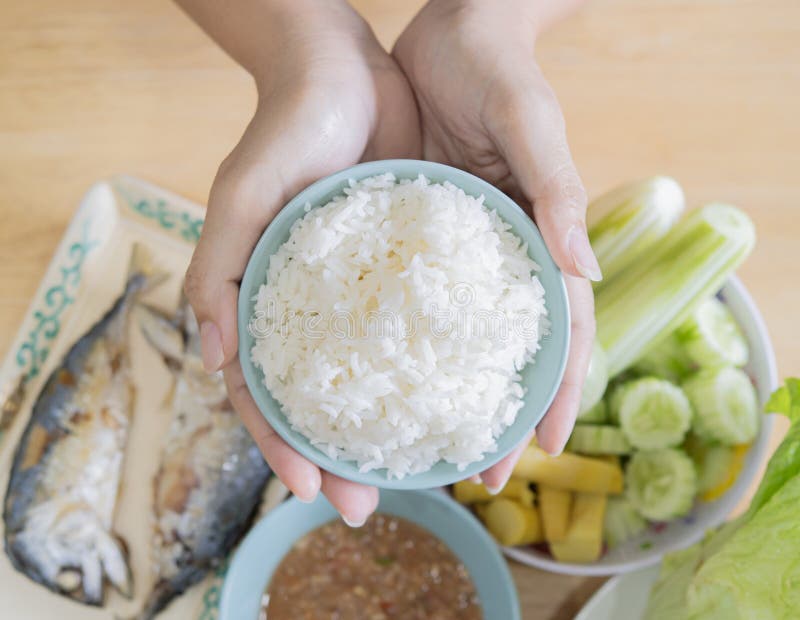 Steamed Rice on Hands Served with Fried Mackerel, Fresh Vegetables ...