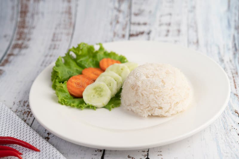 Steamed Rice on a Plate with Cucumber, Salad and Carrots Stock Image ...