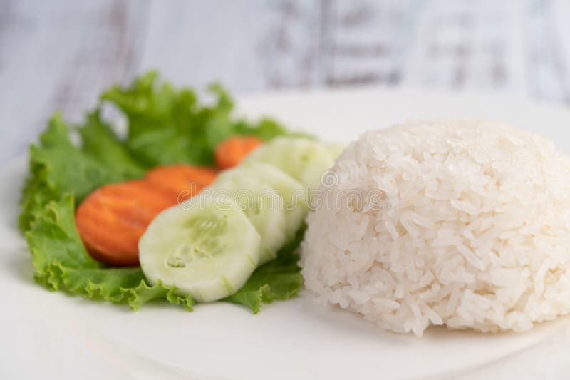 Steamed Rice on a Plate with Cucumber, Salad and Carrots Stock Image ...