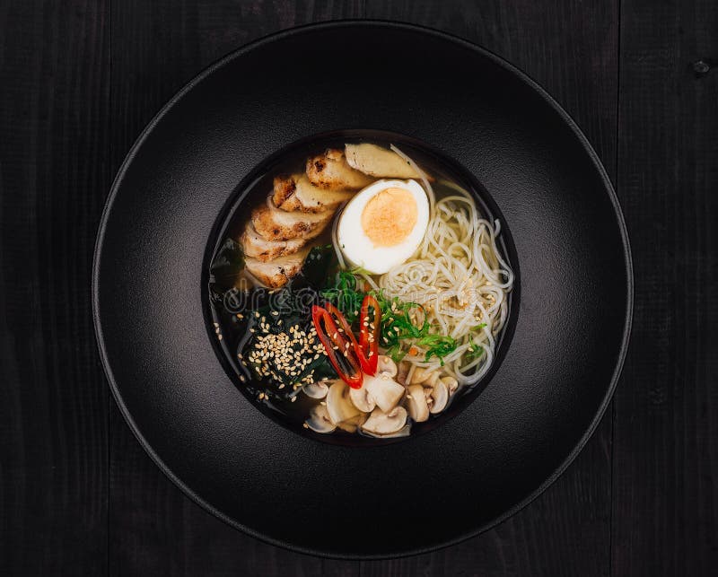 Steaming Bowl of Chicken Ramen on Black Table Setting Stock Image ...