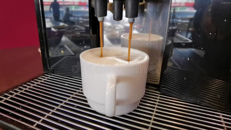Steaming Espresso Pouring into White Mug on Coffee Machine Drip Tray ...