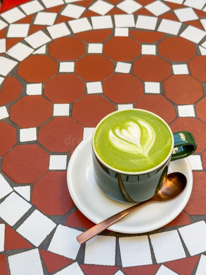 Matcha Latte Resting on a Geometrically Tiled Table. Stock Image ...