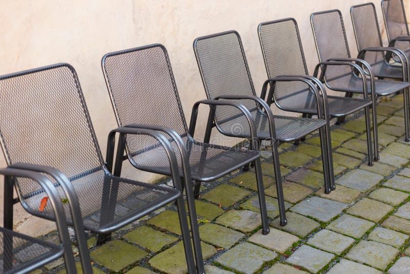 Steel Chairs Against Old Textured Cement Wall Stock Image - Image of ...