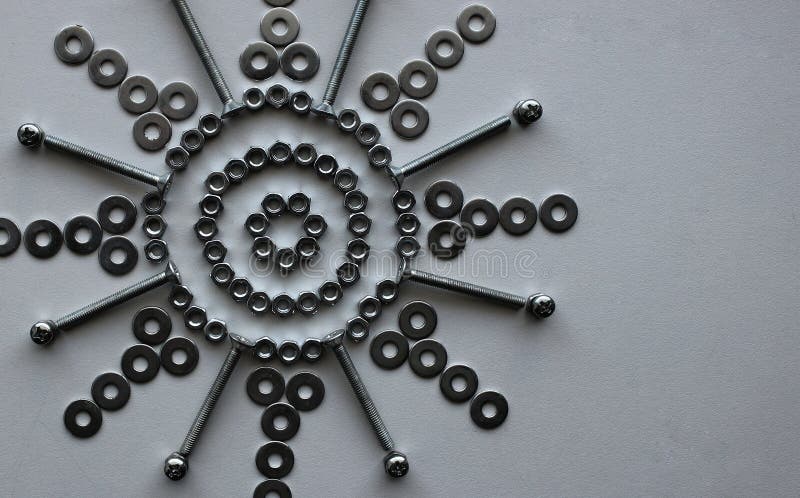 Steel Hardware Items Laid Out in Flower Pattern on White Surface with ...