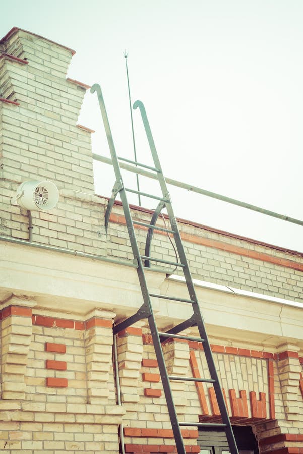 Steel Ladder on Brick Building with Sun Flare Stock Photo - Image of ...