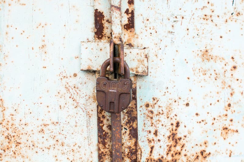 Steel Lock on the Rusty Grey Metal Door. Close-up Stock Photo - Image ...