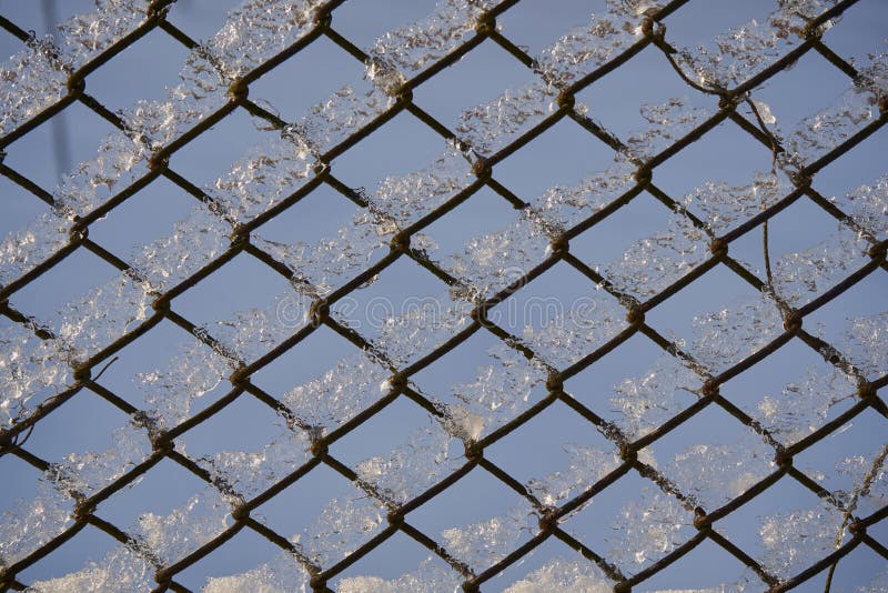 A Steel Mesh with Ice, Old Fence Mesh Covered with Ice in the Sun Stock ...