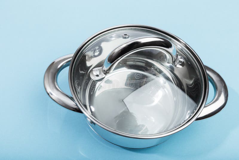 Steel Pan with a Transparent Lid on Blue Background Stock Photo - Image ...