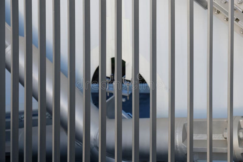 Intricate Arrangement of Metal Pipes and Barriers in an Industrial ...