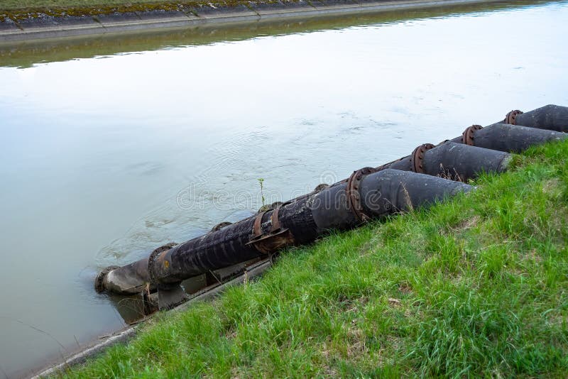 Steel Pipes Leading Below the Water Level Stock Photo - Image of stack ...