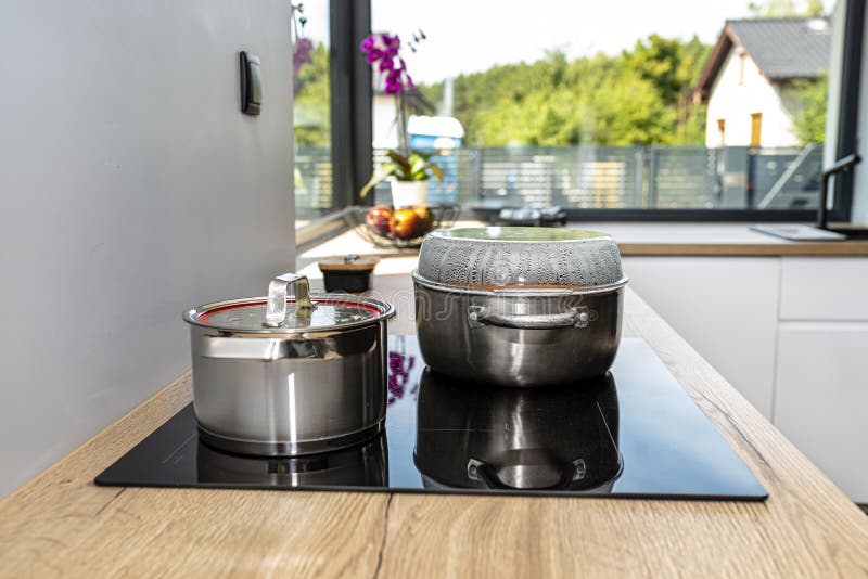 Steel Pots with a Cooking Dish on an Induction Cooker Built into the ...