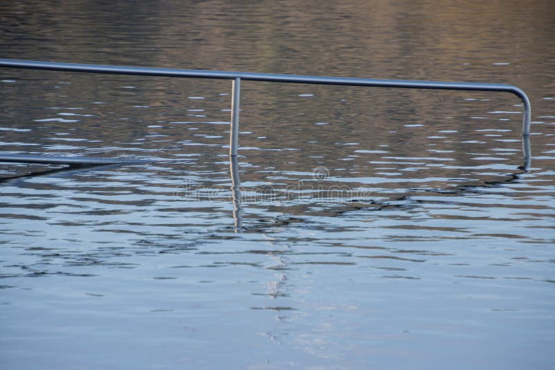 Steel railing in the water stock photo. Image of security - 349966364