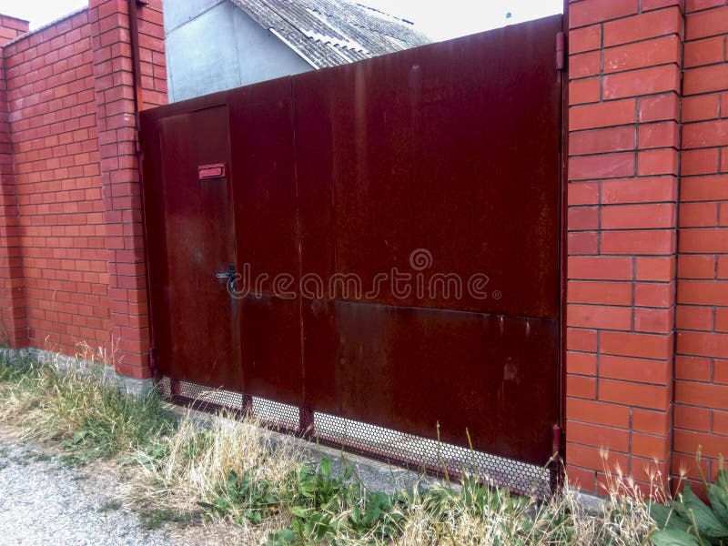 Steel Rusty Gates and a Red Brick Fence. Stock Photo - Image of gate ...